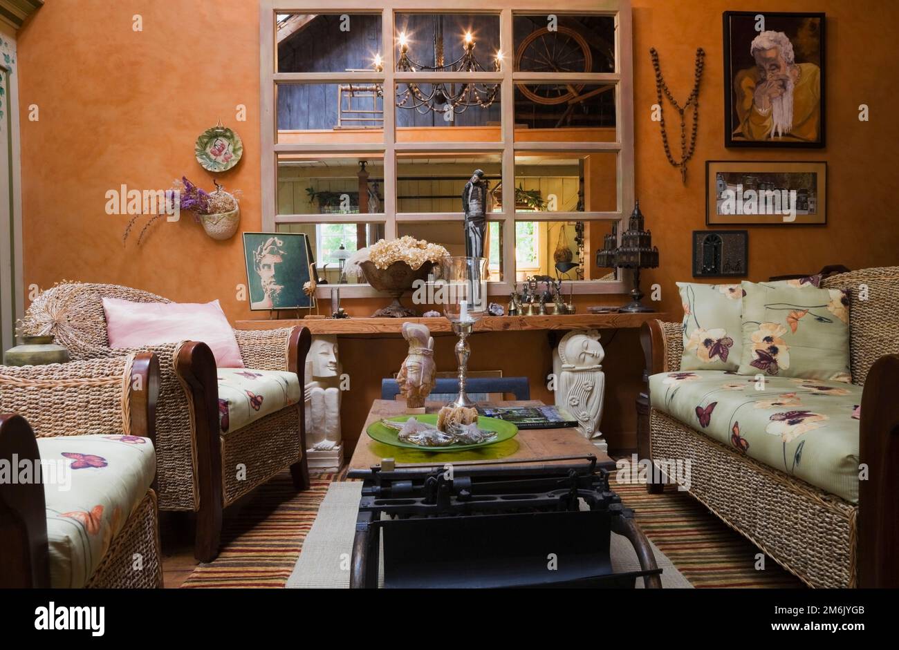 Wicker armchairs, love seat and wooden coffee table in living room ...
