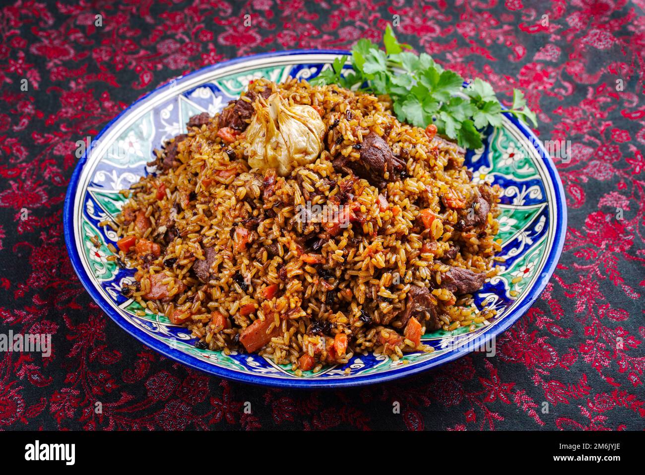 Traditional Uzbek fergana plov with devsira rice and lamb meat served ...