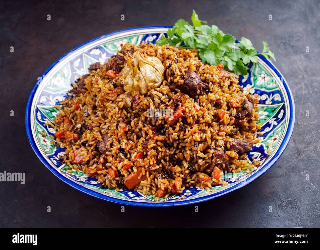 Traditional Uzbek fergana plov with devsira rice and lamb meat served ...