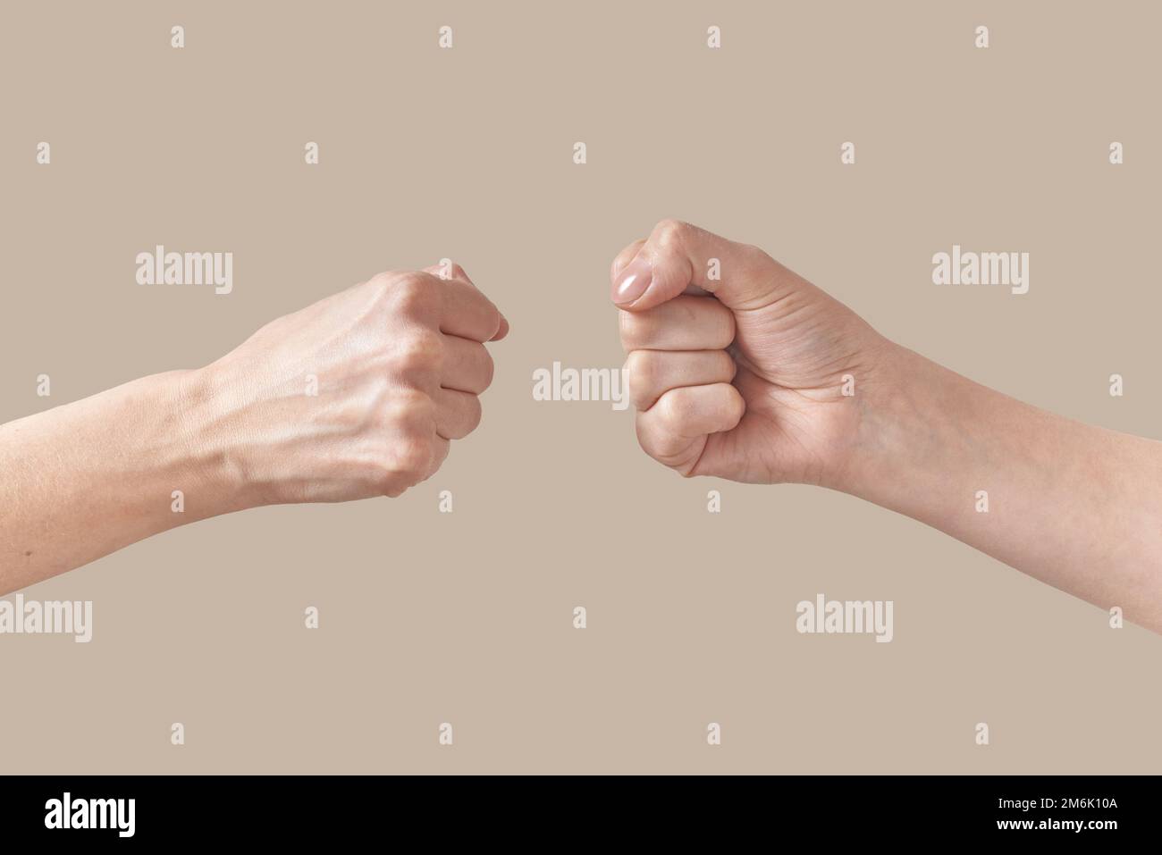 Male and female hands fist bump isolated on beige Stock Photo - Alamy