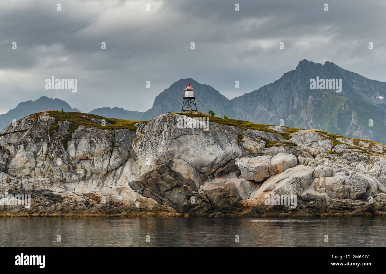 Norwegian seascape, lighthouse on the island, rocky coast with dramatic ...