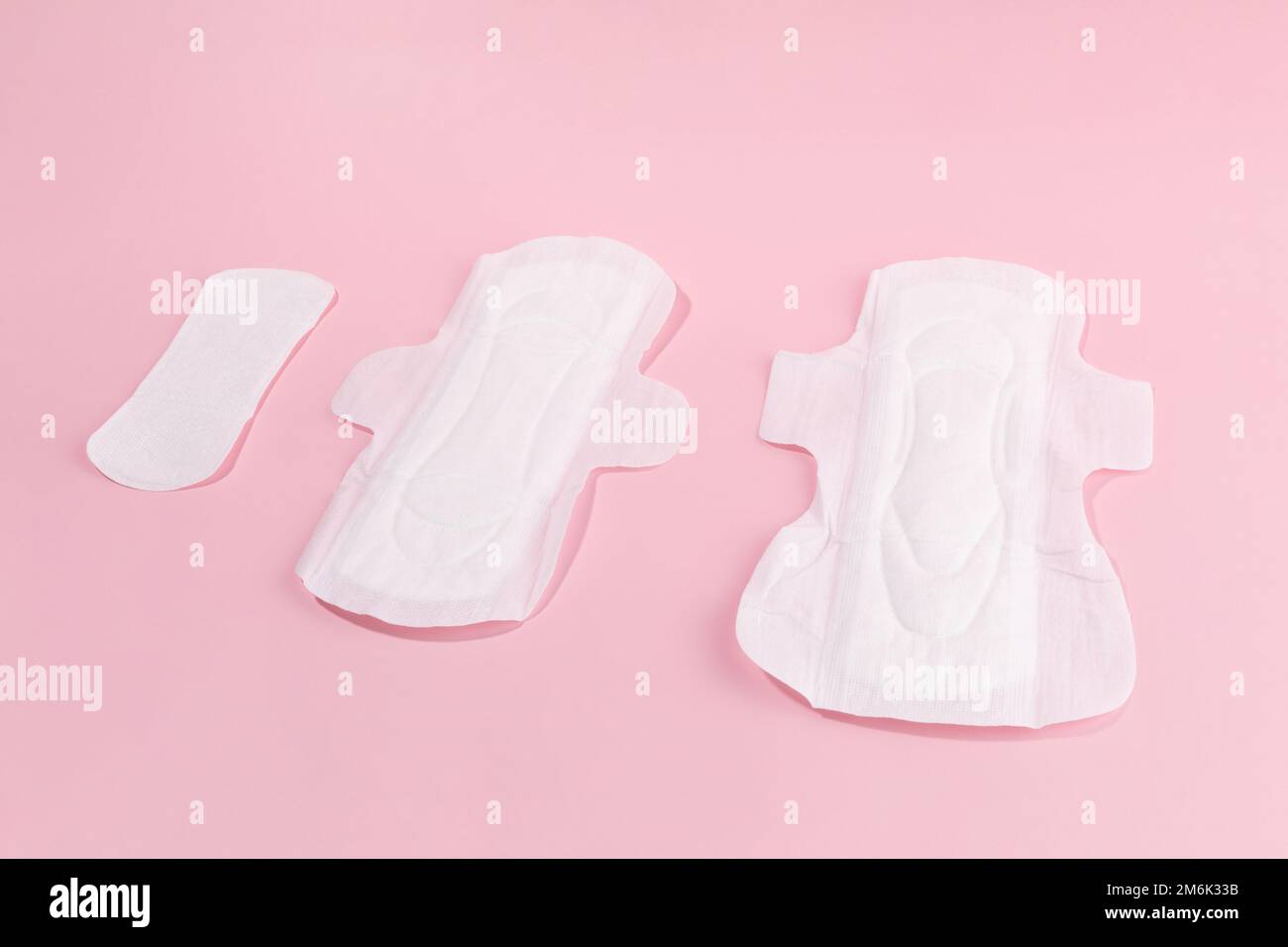 woman menstrual products compare sanitary pad size Stock Photo - Alamy