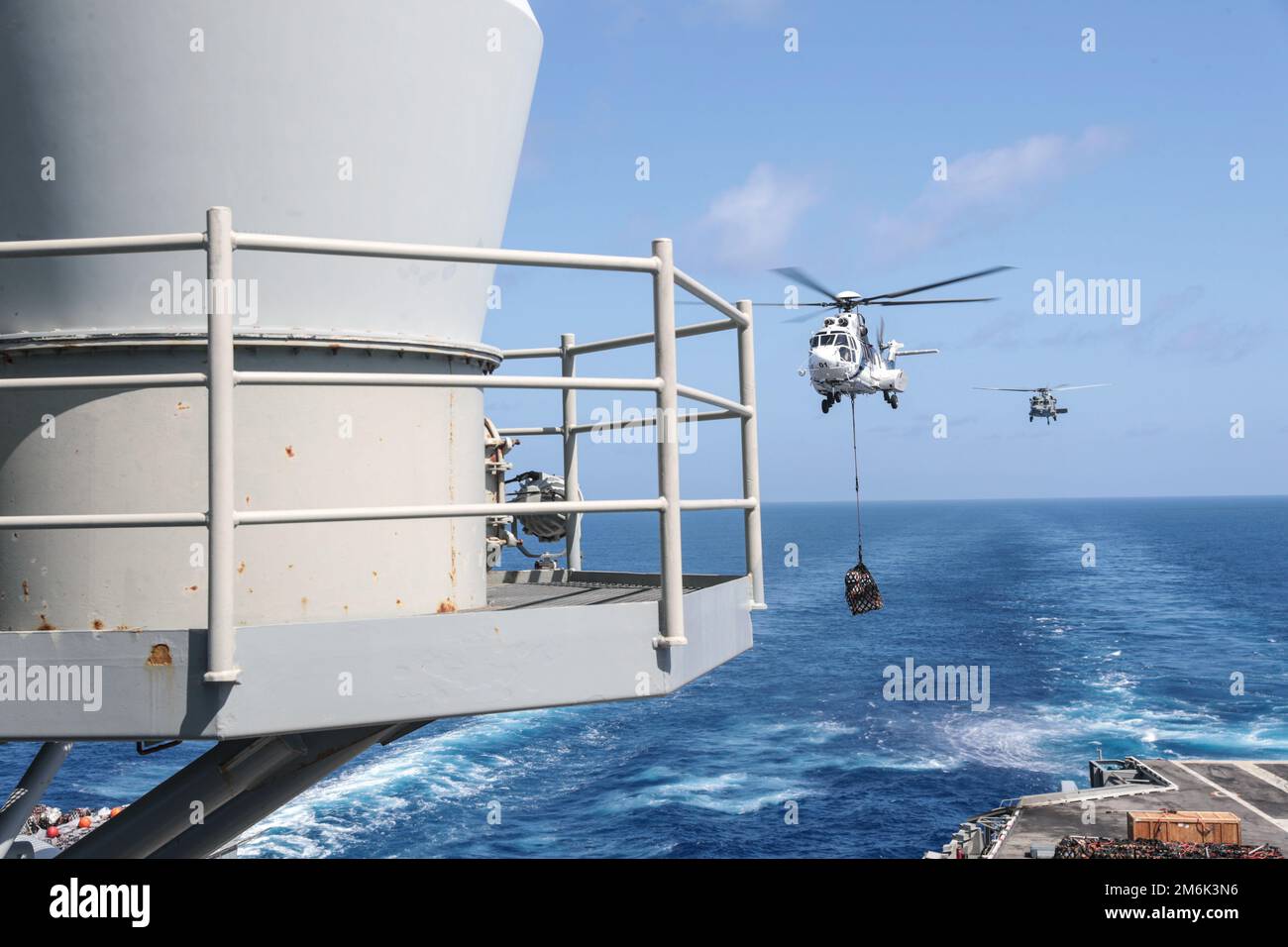 PHILIPPINE SEA (April 29, 2022) An AS332 Super Puma transports cargo to ...