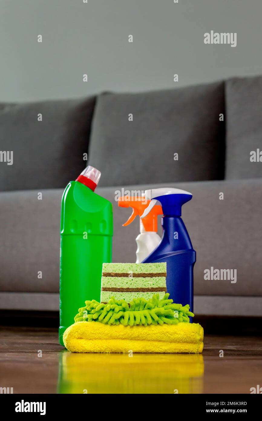 Household cleaning products and rags on floor. Chemical liquids for ...