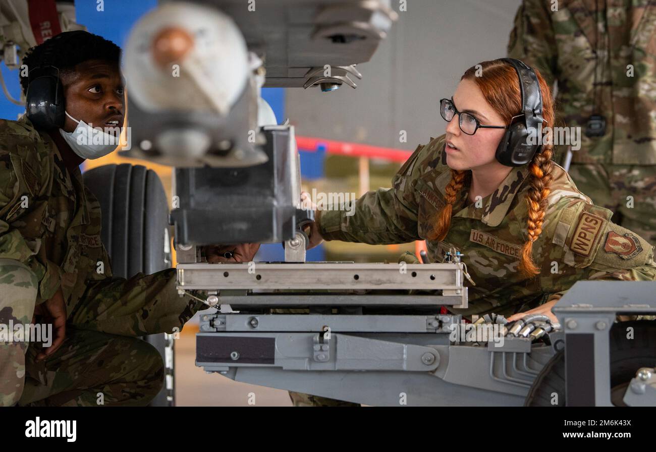 A 96th Aircraft Maintenance Squadron Red team moves a GBU into place ...