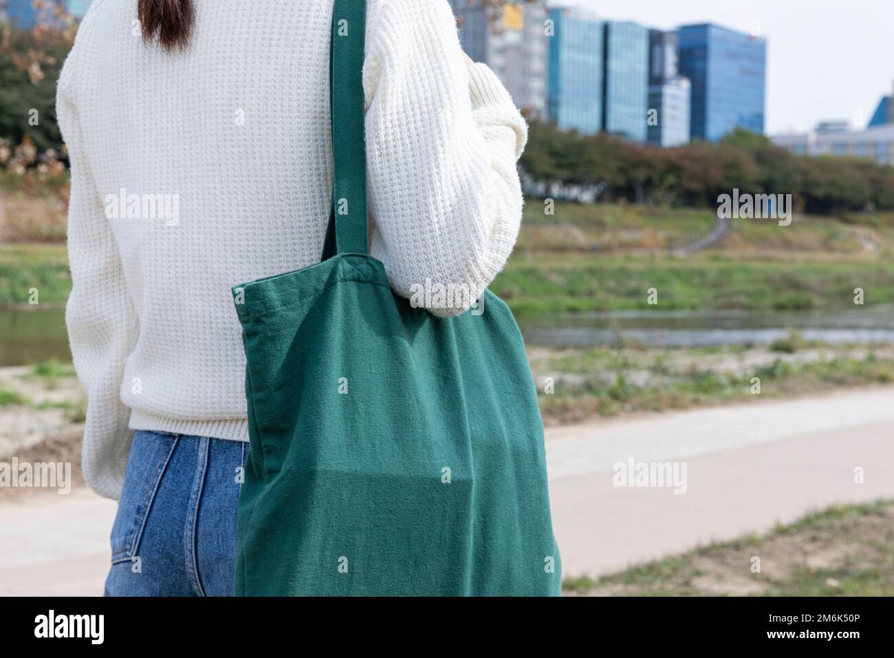 eco friendly habits hand gesture carrying eco bag Stock Photo - Alamy