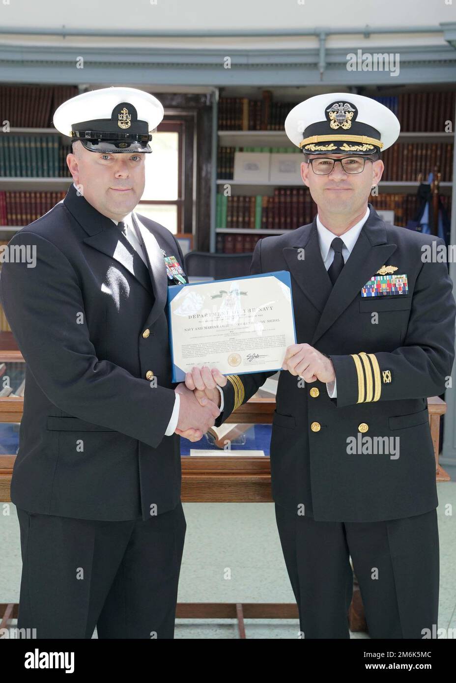 Seabee Chief Michael Baxter (left) was presented the Naval Commendation ...
