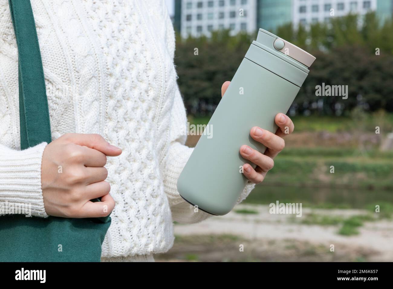 eco friendly habits hand gesture holding a tumbler Stock Photo - Alamy
