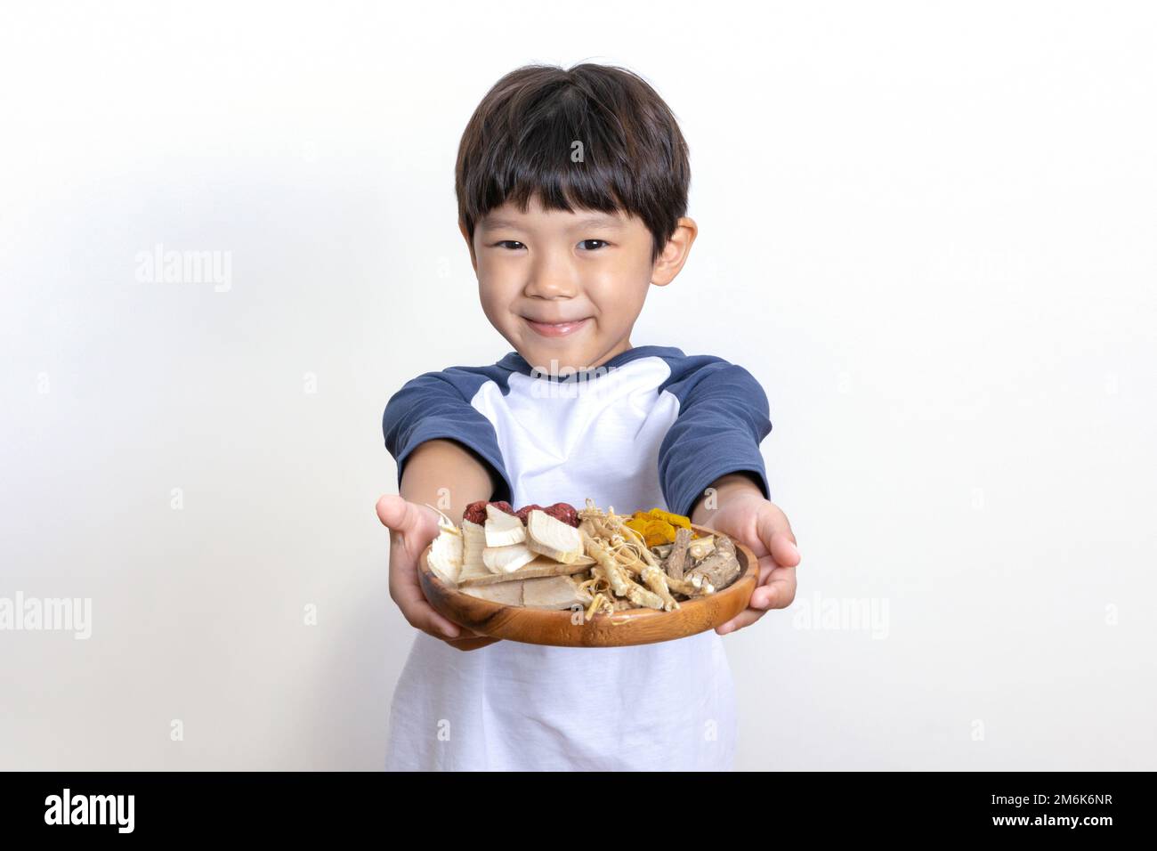 Asian Korean child holding herbal medicine Stock Photo - Alamy