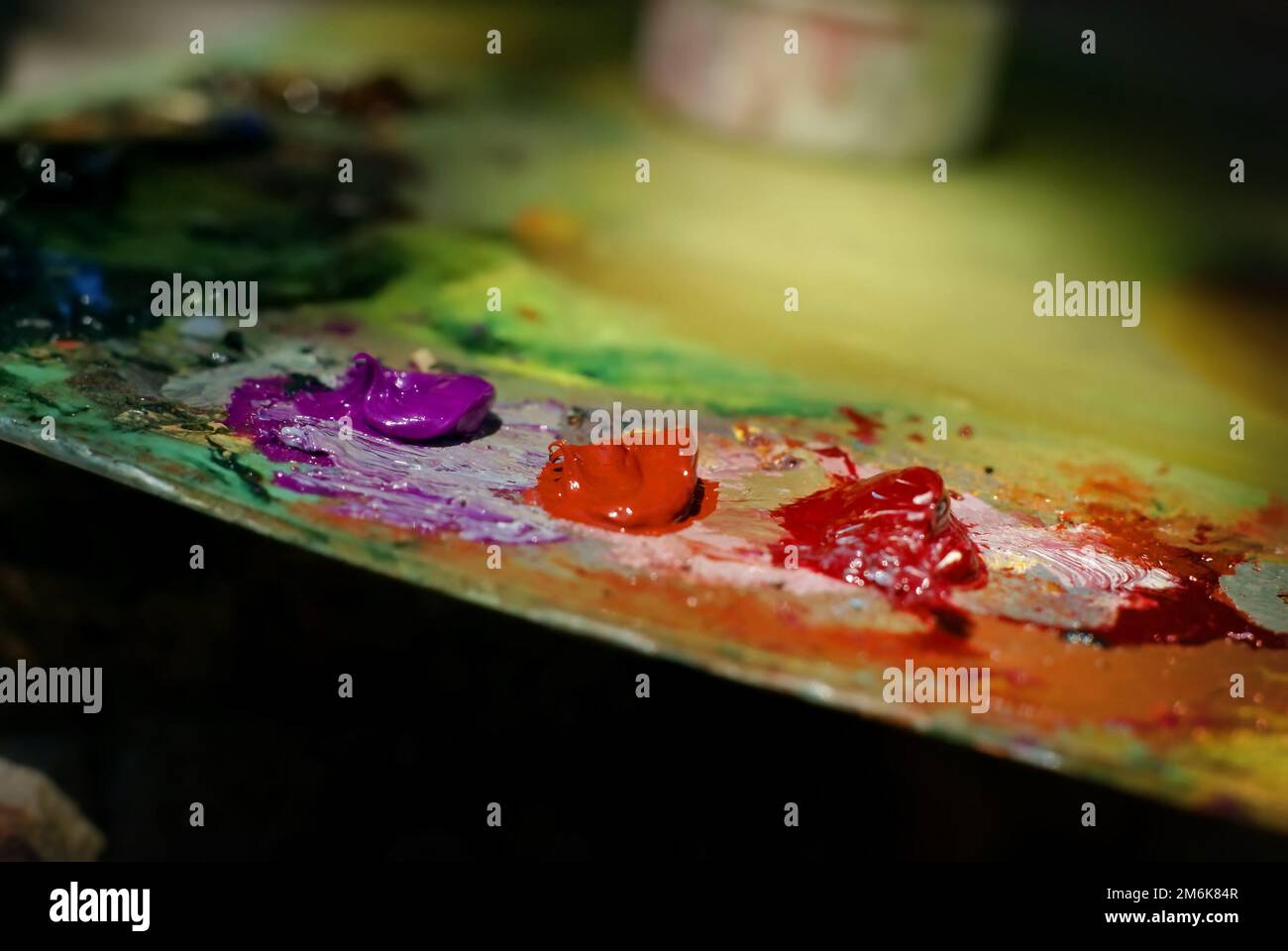 Artist brush mix color oil painting on palette is holding in his hand ...