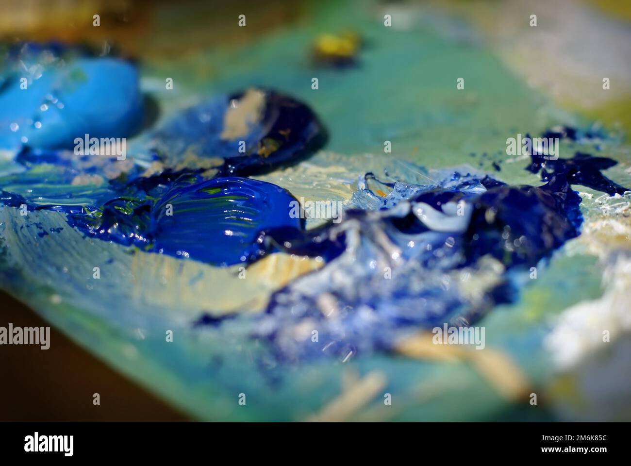 Artist brush mix color oil painting on palette is holding in his hand ...