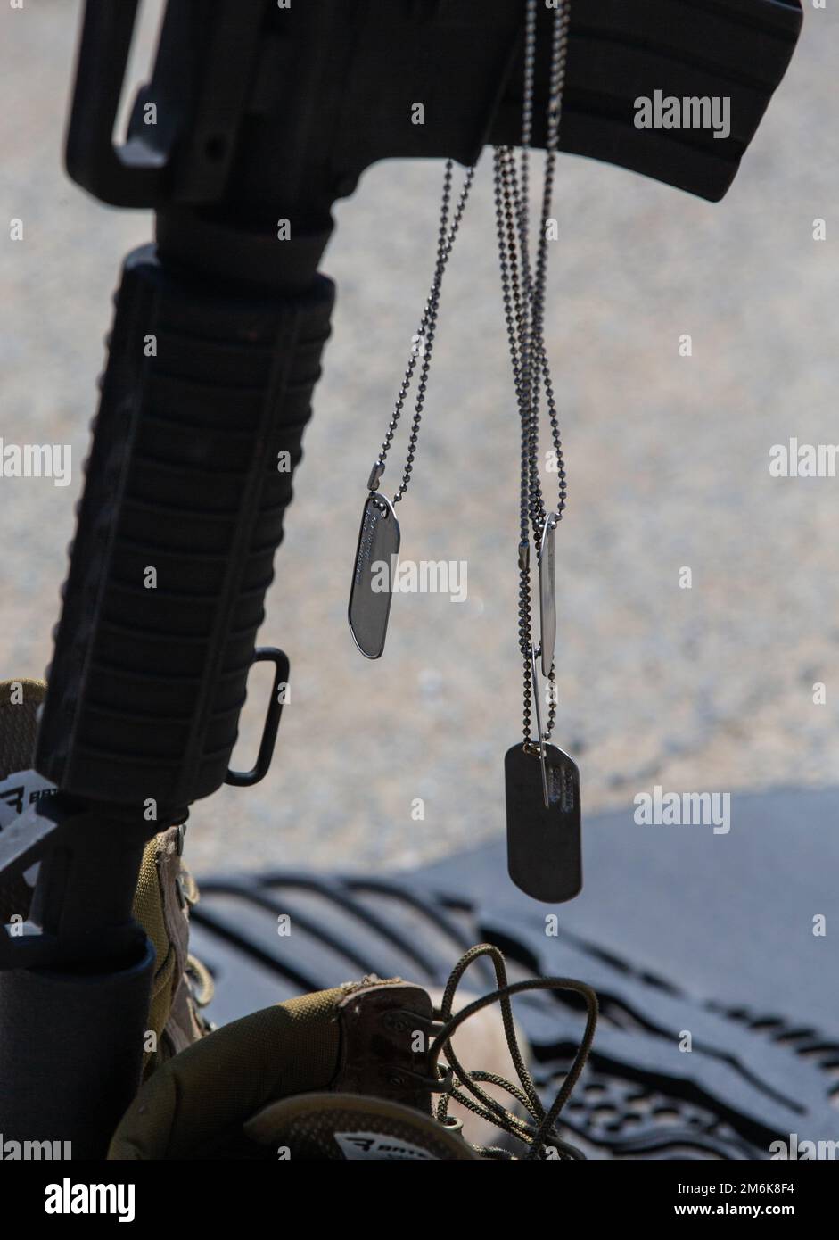 U.S. Marines place dog tags on a battlefield cross at the end of the ...
