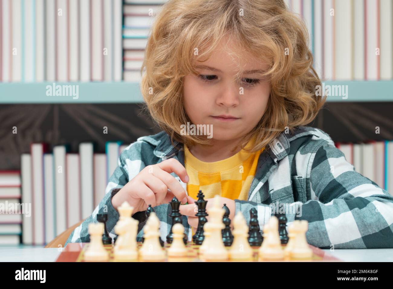 Little chess player. Chess school. Child think about chess game ...