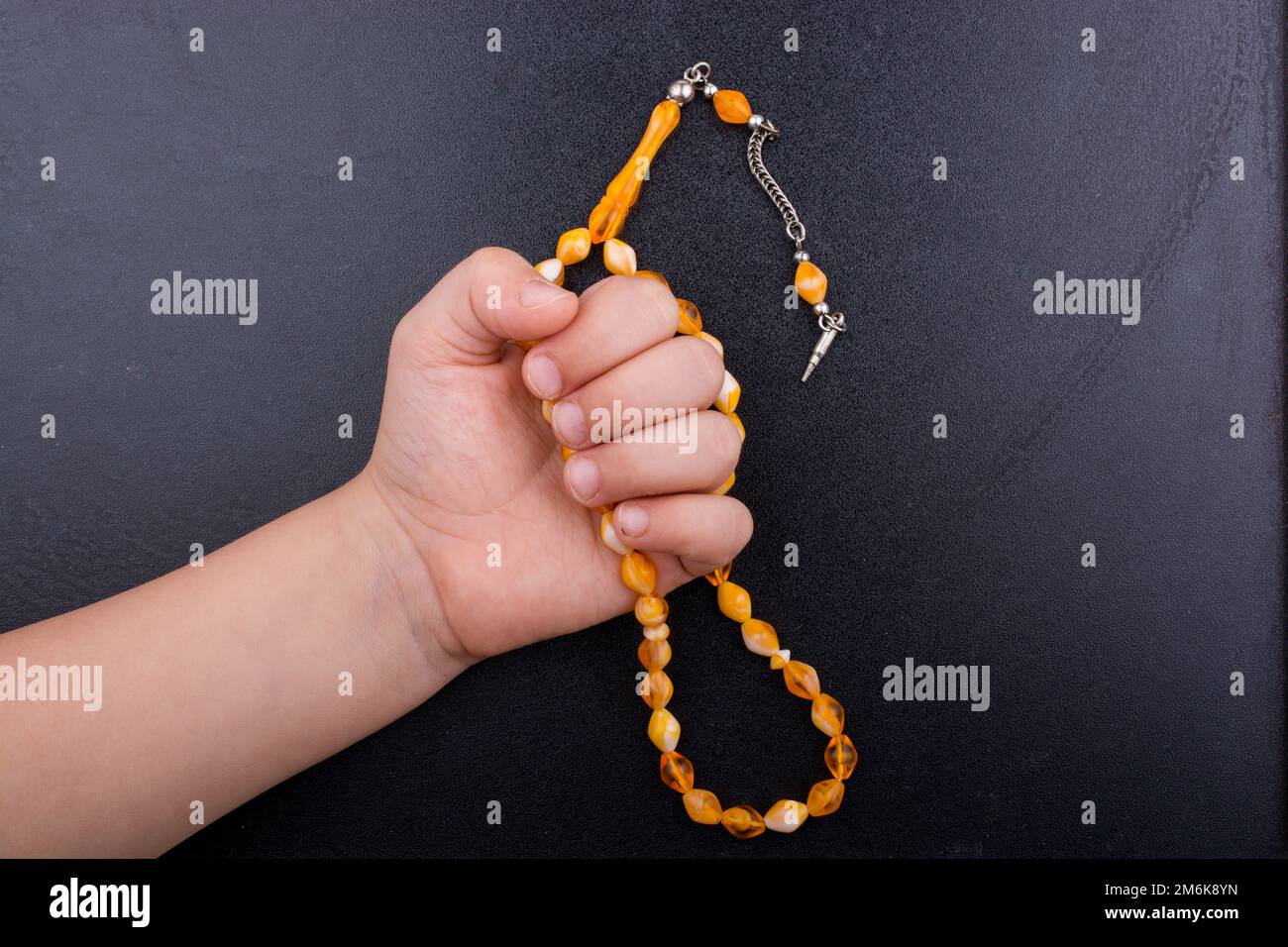 Praying beads of various color in hand Stock Photo - Alamy