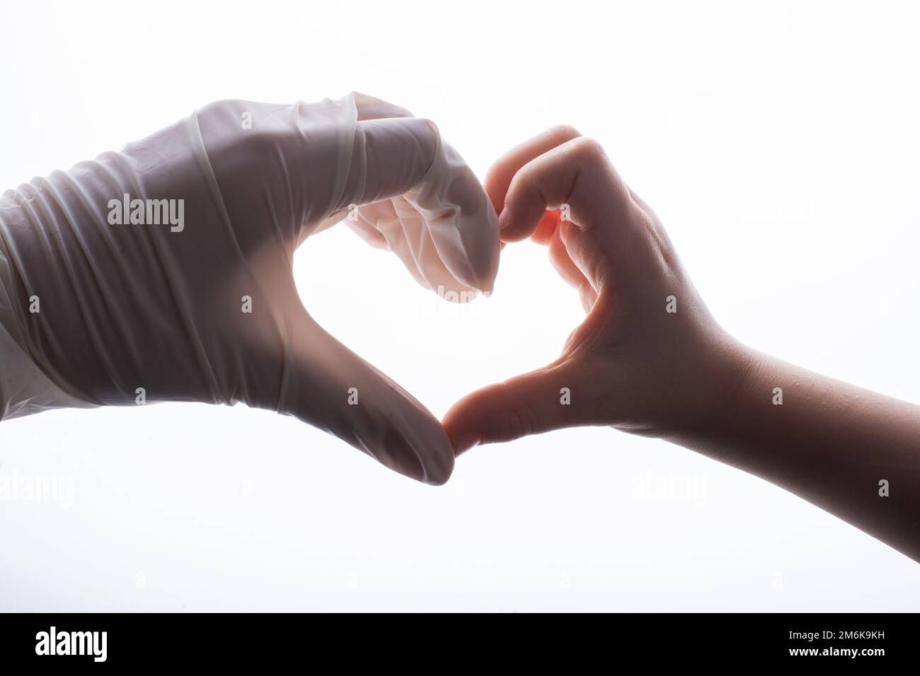Putting on latex gloves on hands for protection make heart shape Stock ...