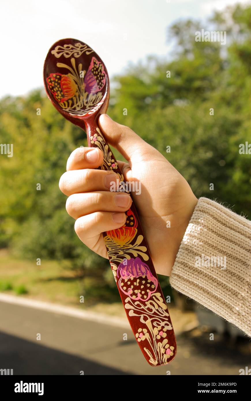 Hand holding a spoon Stock Photo - Alamy