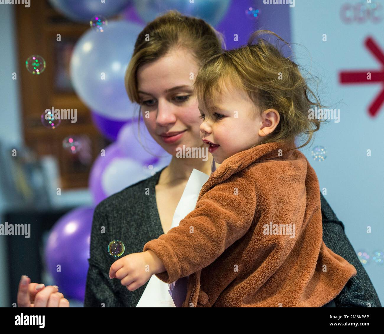 A child and her mother catch bubbles as they depart the Wright Care ...