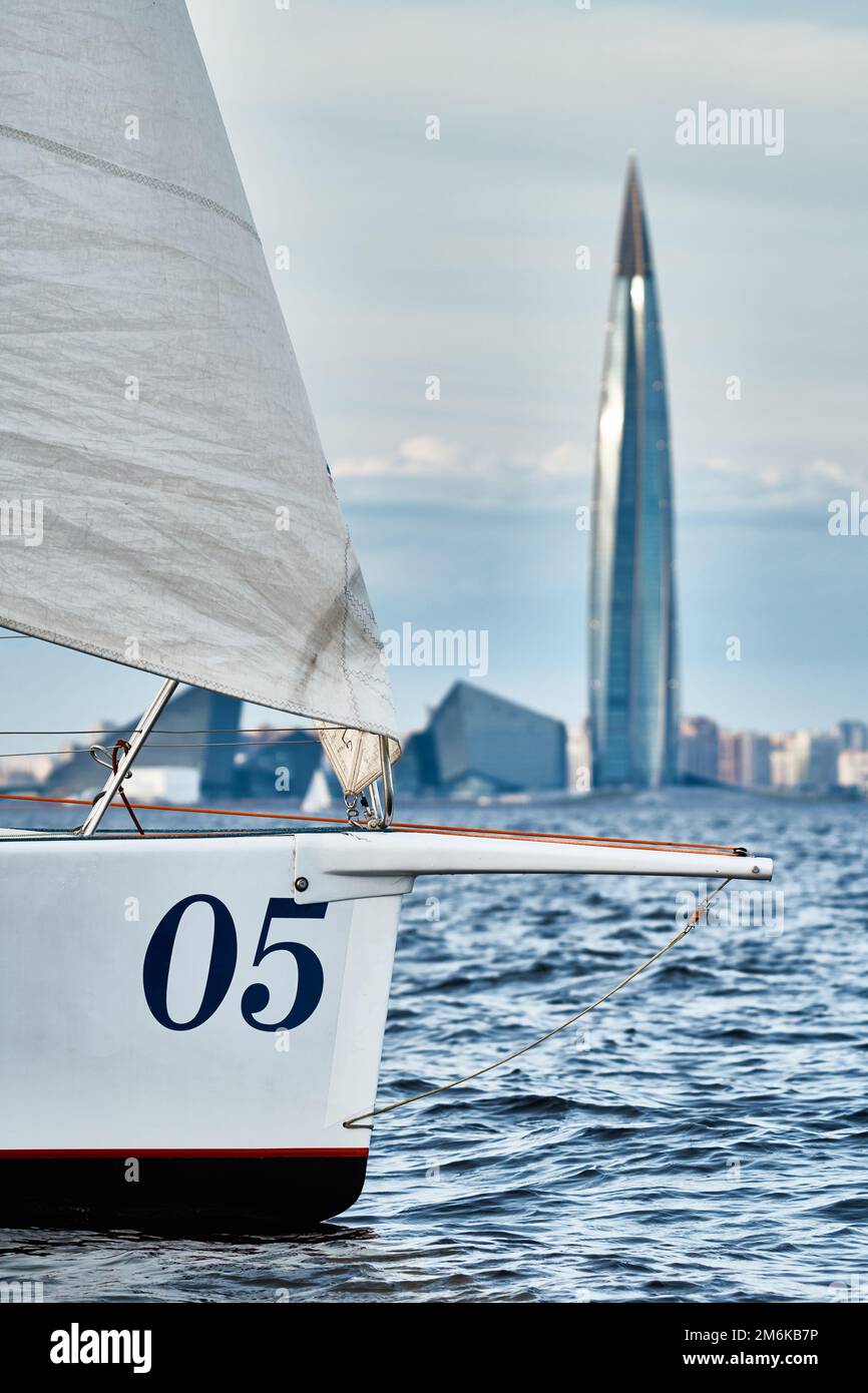 Bowsprit of sailing yacht in sailing regatta at sunset, still water ...