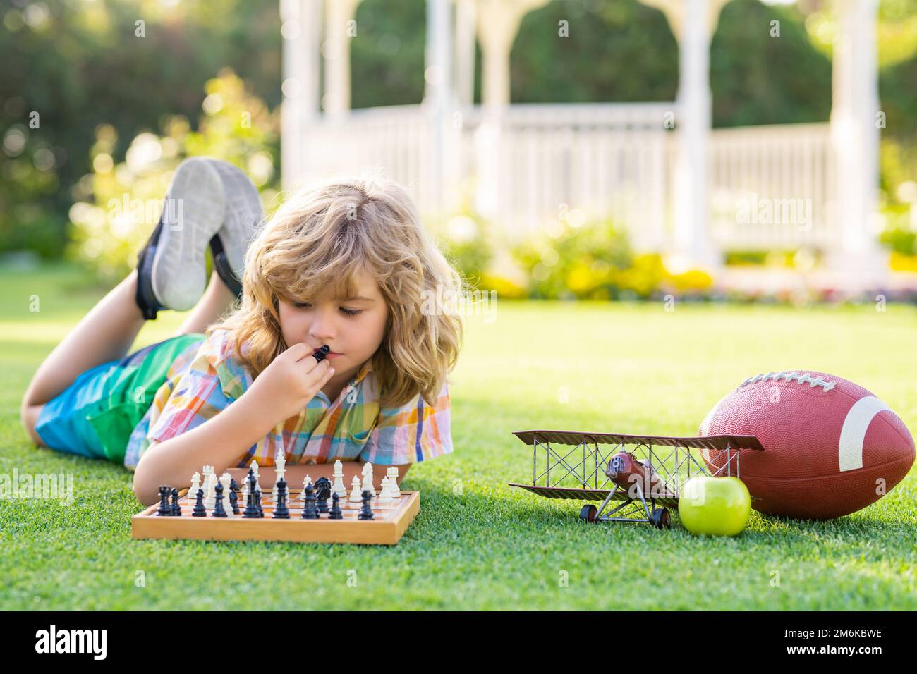Summer games and outdoor activities for kids. Concentrated child boy ...