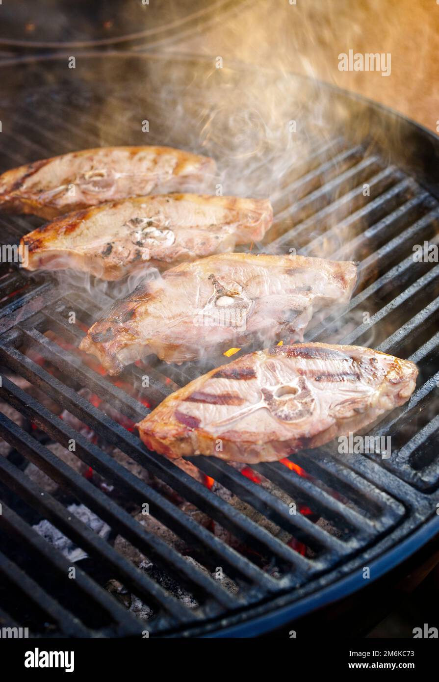 Barbecue lamb saddle back chop steak grilled as close-up on a charcoal ...