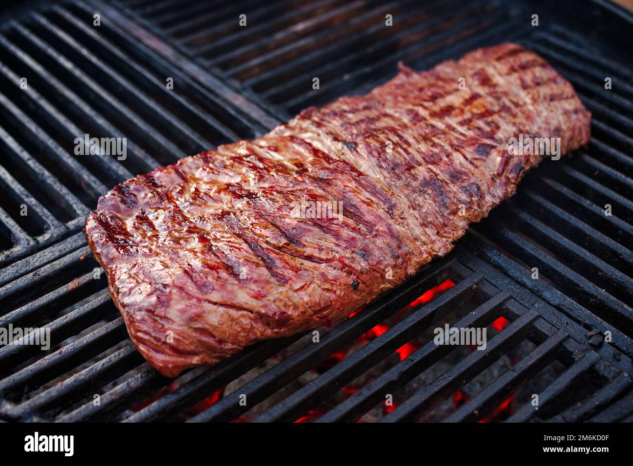 Traditional American barbecue bavette steak as close-up on a charcoal ...