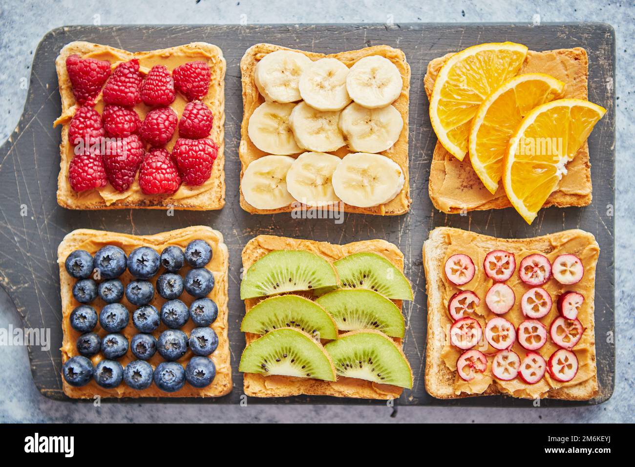 Wholegrain bread slices with peanut butter and various fruits Stock ...