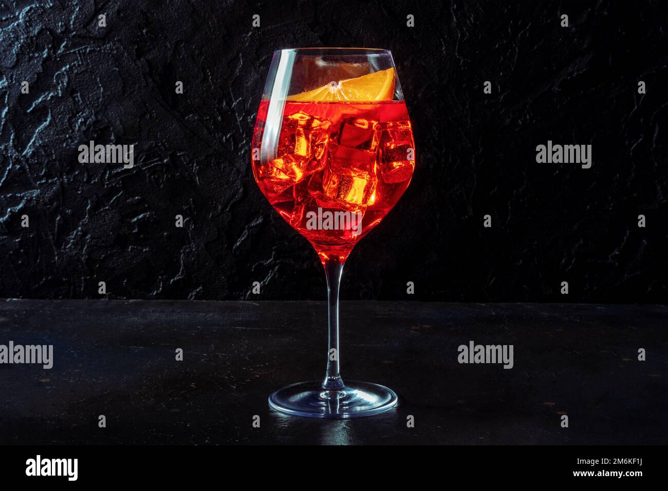 Aperol cocktail with a fresh orange slice, a side view on a black ...