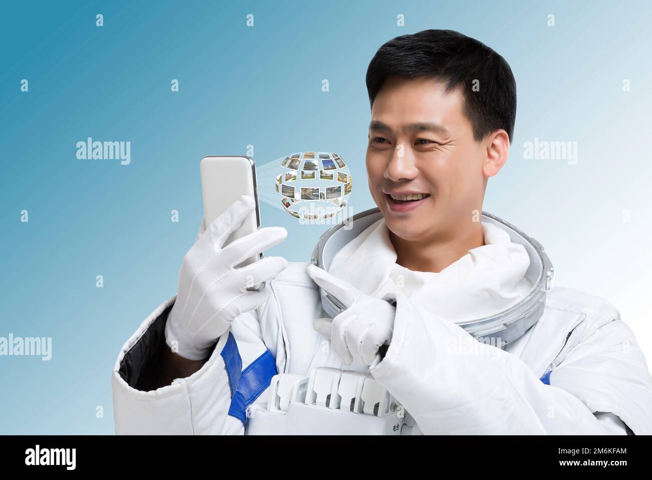 Male astronauts display mobile phone and the hologram Stock Photo - Alamy