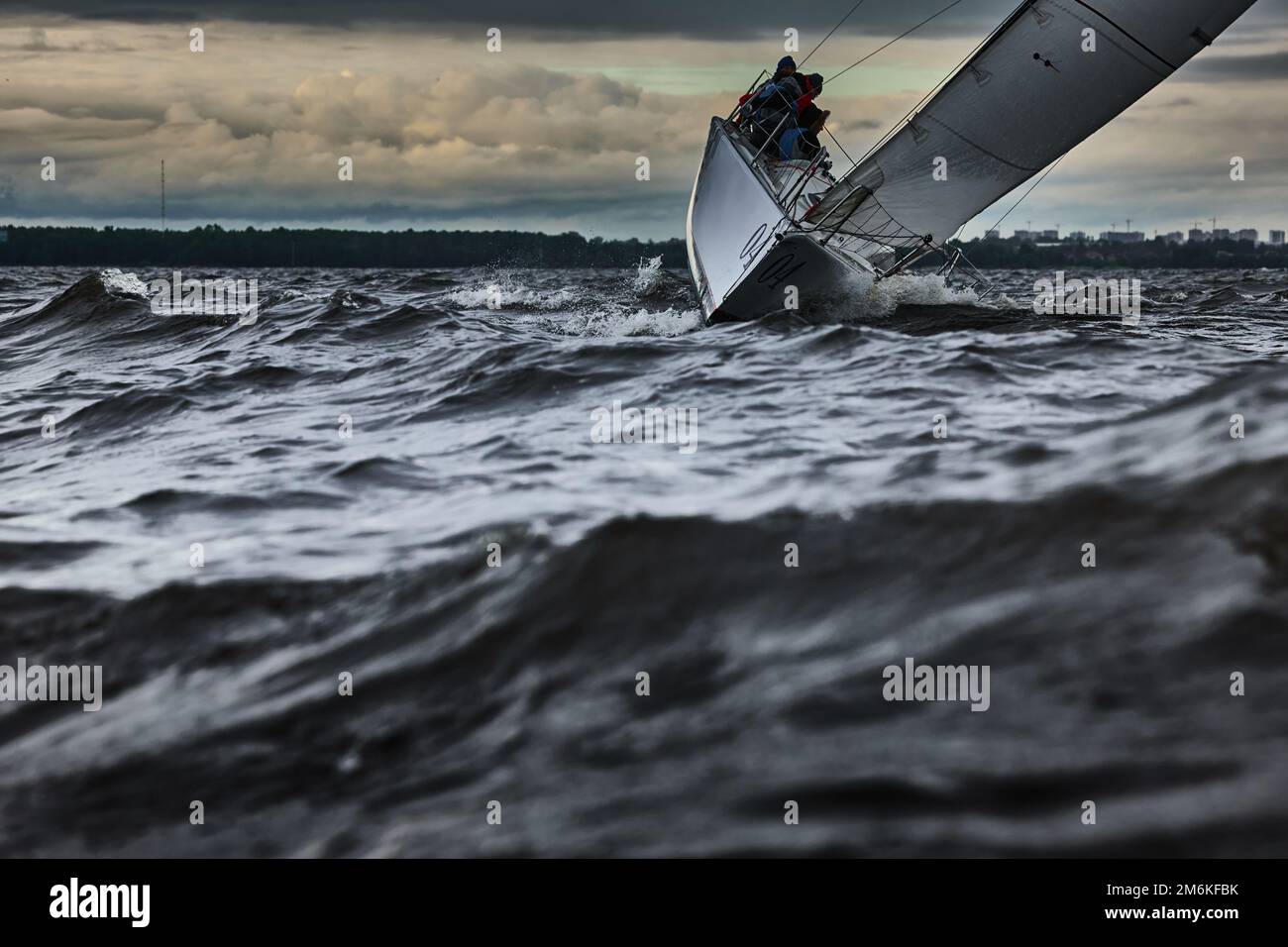 Sailboat in sea at stormy weather, stormy clouds sky orange sky, sail ...