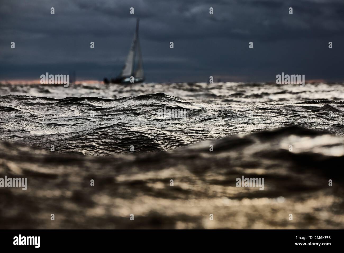 Sailboat in sea at stormy weather, blurred background, stormy clouds ...