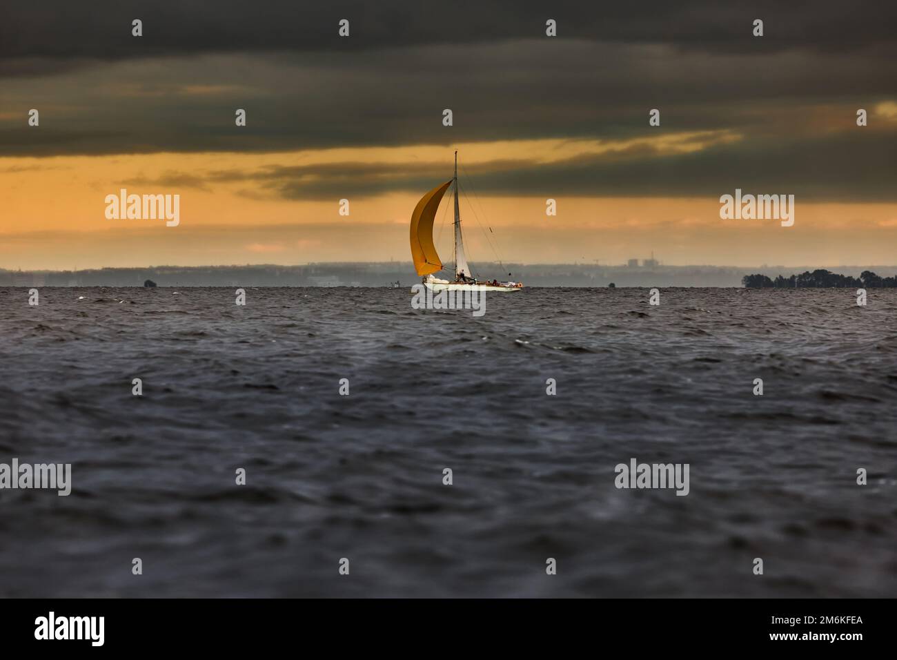 Sailboat in sea at stormy weather, stormy clouds sky orange sky, sail ...