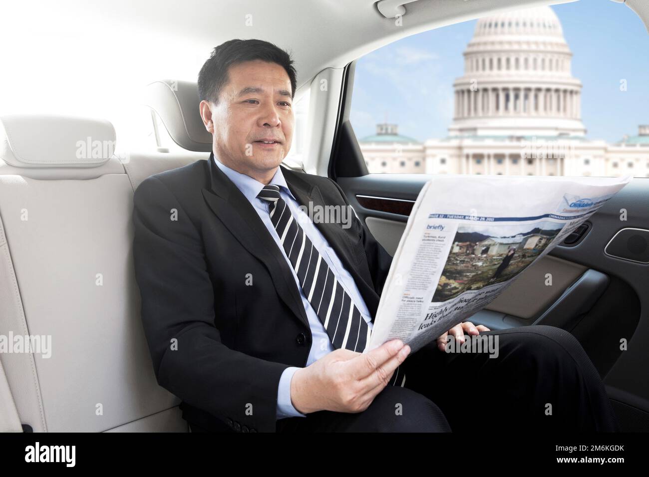 Business man reading a newspaper in the sitting car Stock Photo - Alamy