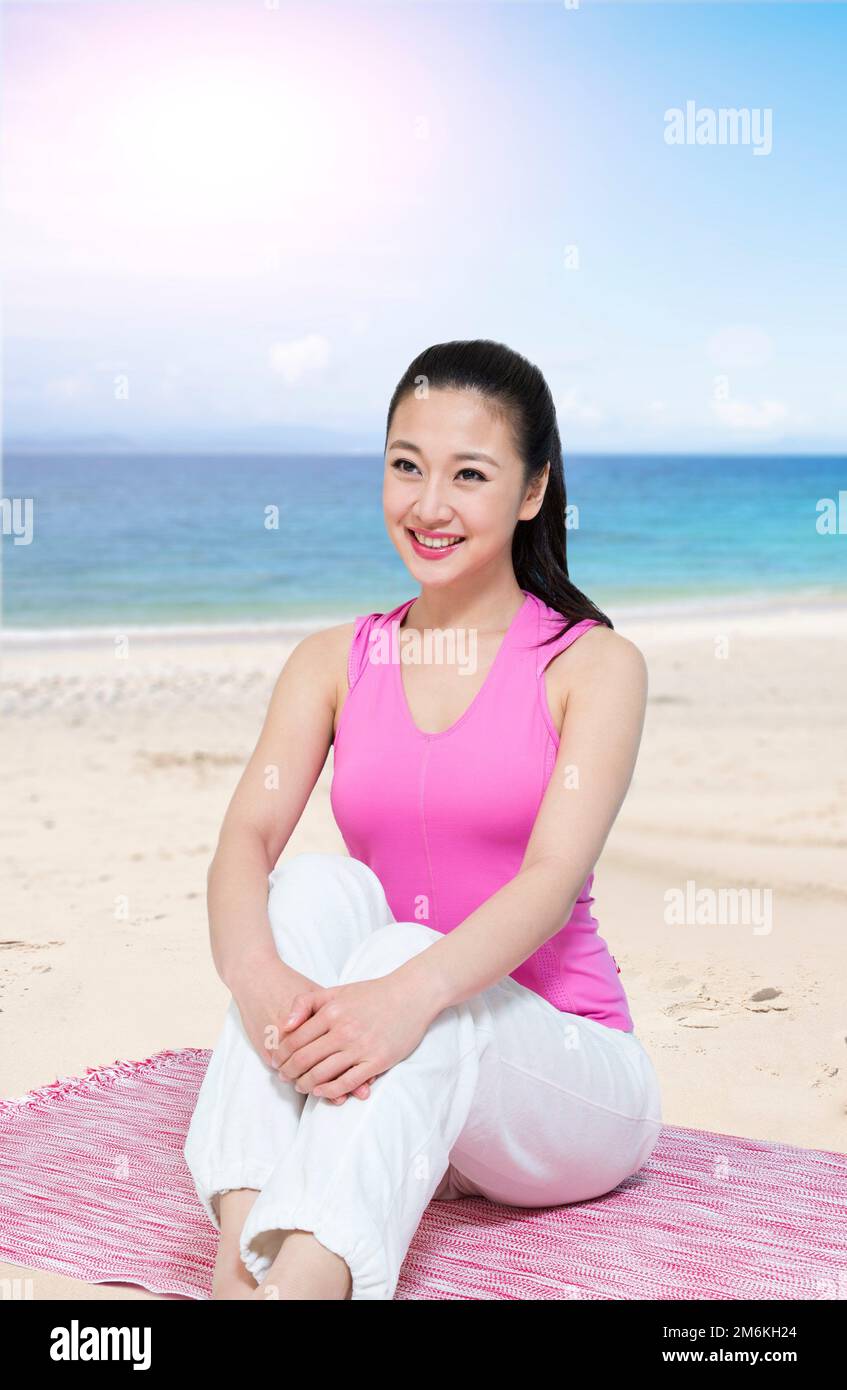 Shed young woman sit down to rest on the carpet Stock Photo - Alamy