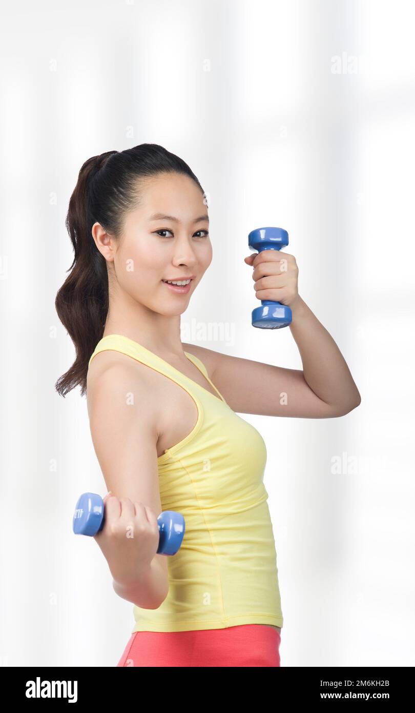 Take young woman dumbbell shed Stock Photo - Alamy