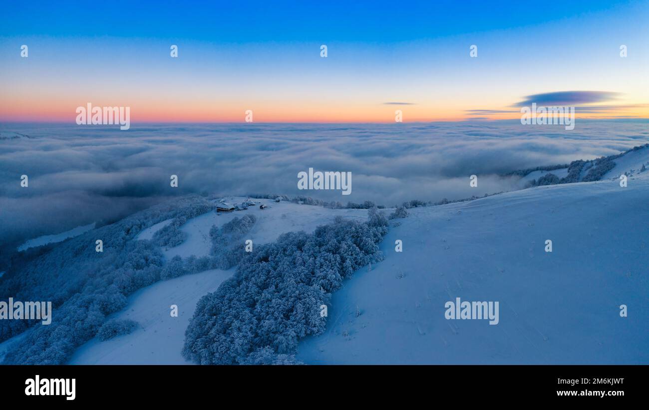 Snow-covered mountain peaks at dawn. View from a drone. Ukrainian ...