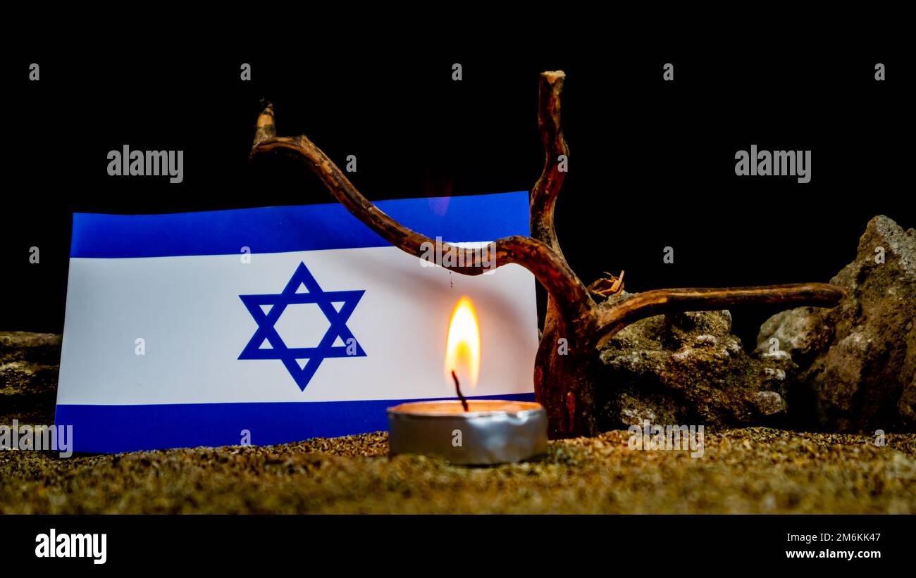 Israeli flag and burning candles in front of it, Holocaust memory day ...