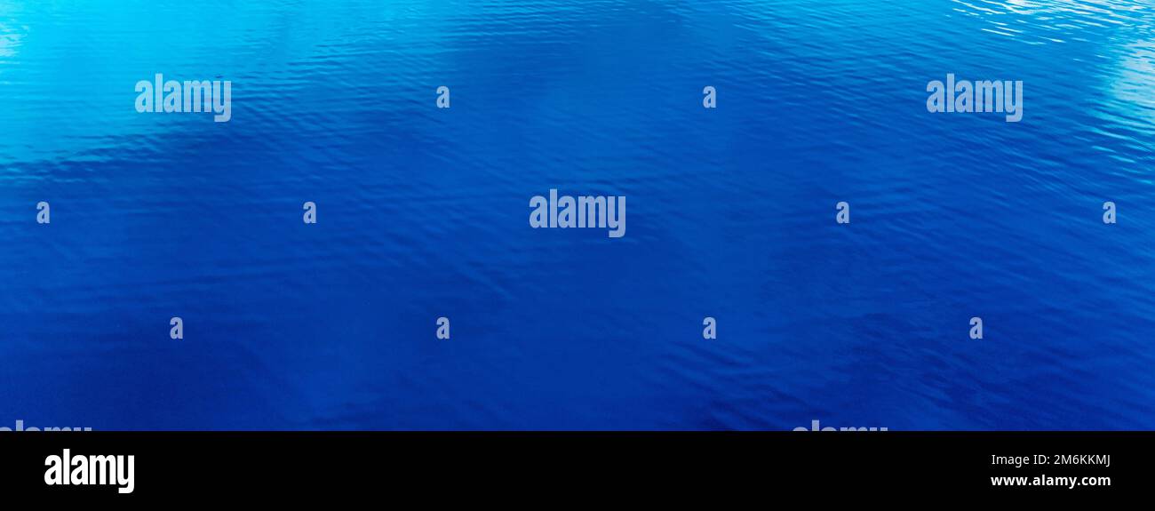 Blue water texture, on the surface of a clear blue lake. Abstract ...