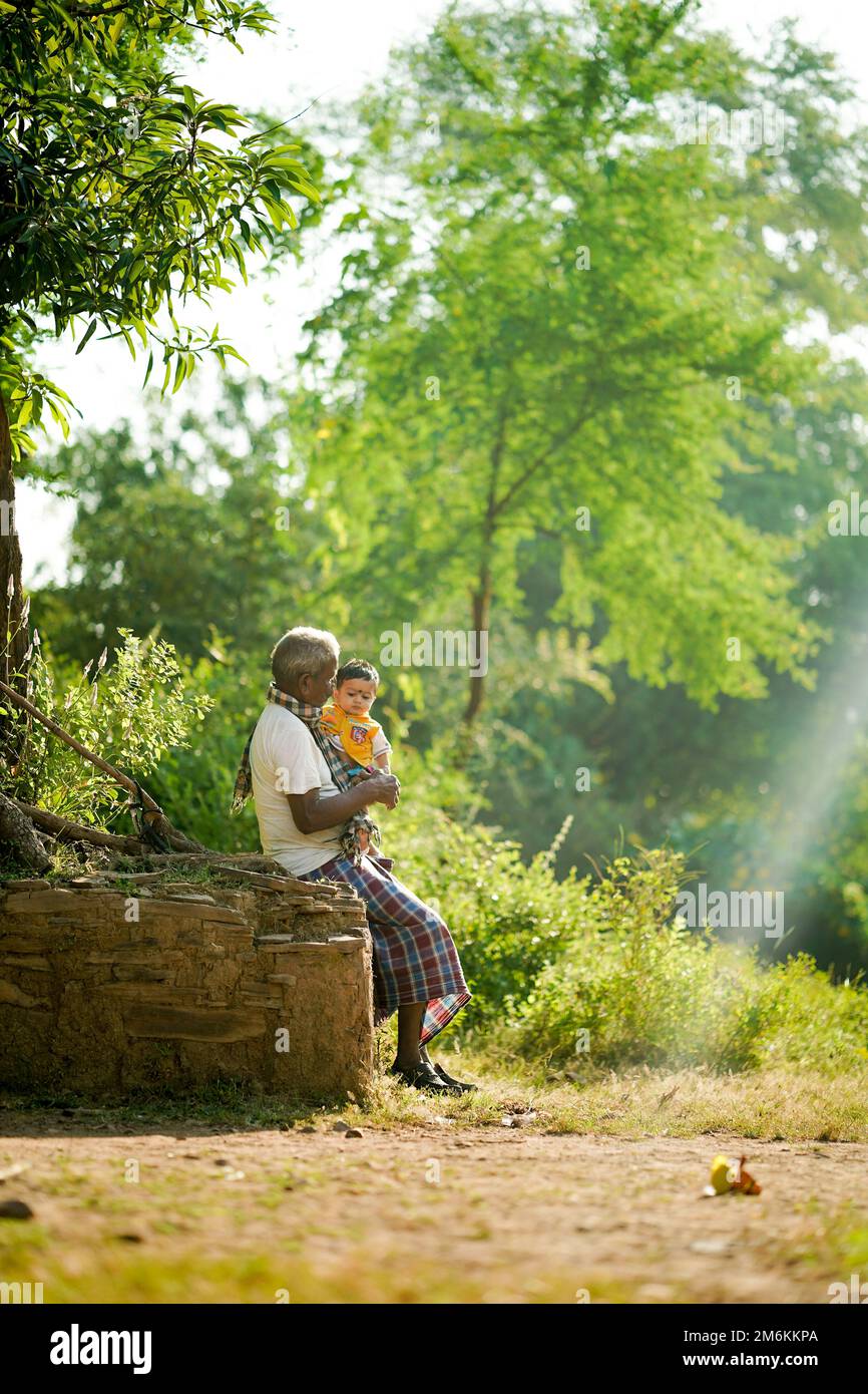 NOVEMBER 15 2022, KACHANDA, CHHATTISGARH, INDIA: Grandfather holding ...