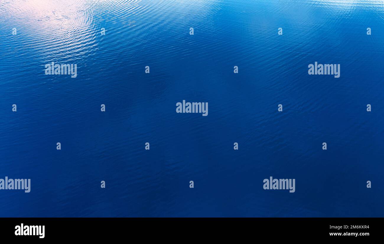 Blue water texture, on the surface of a clear blue lake. Abstract ...