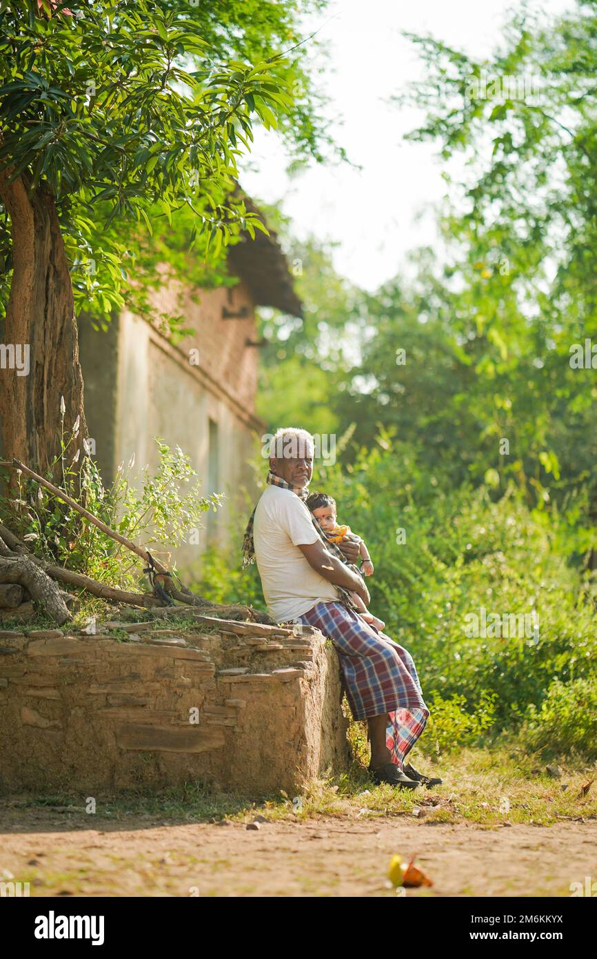 NOVEMBER 15 2022, KACHANDA, CHHATTISGARH, INDIA: Grandfather holding ...