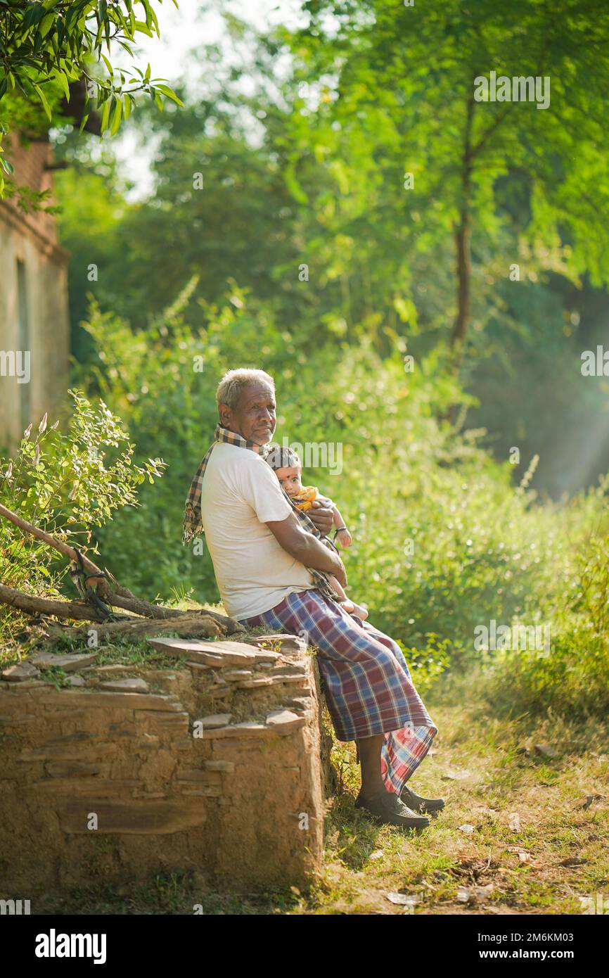 NOVEMBER 15 2022, KACHANDA, CHHATTISGARH, INDIA: Grandfather holding ...