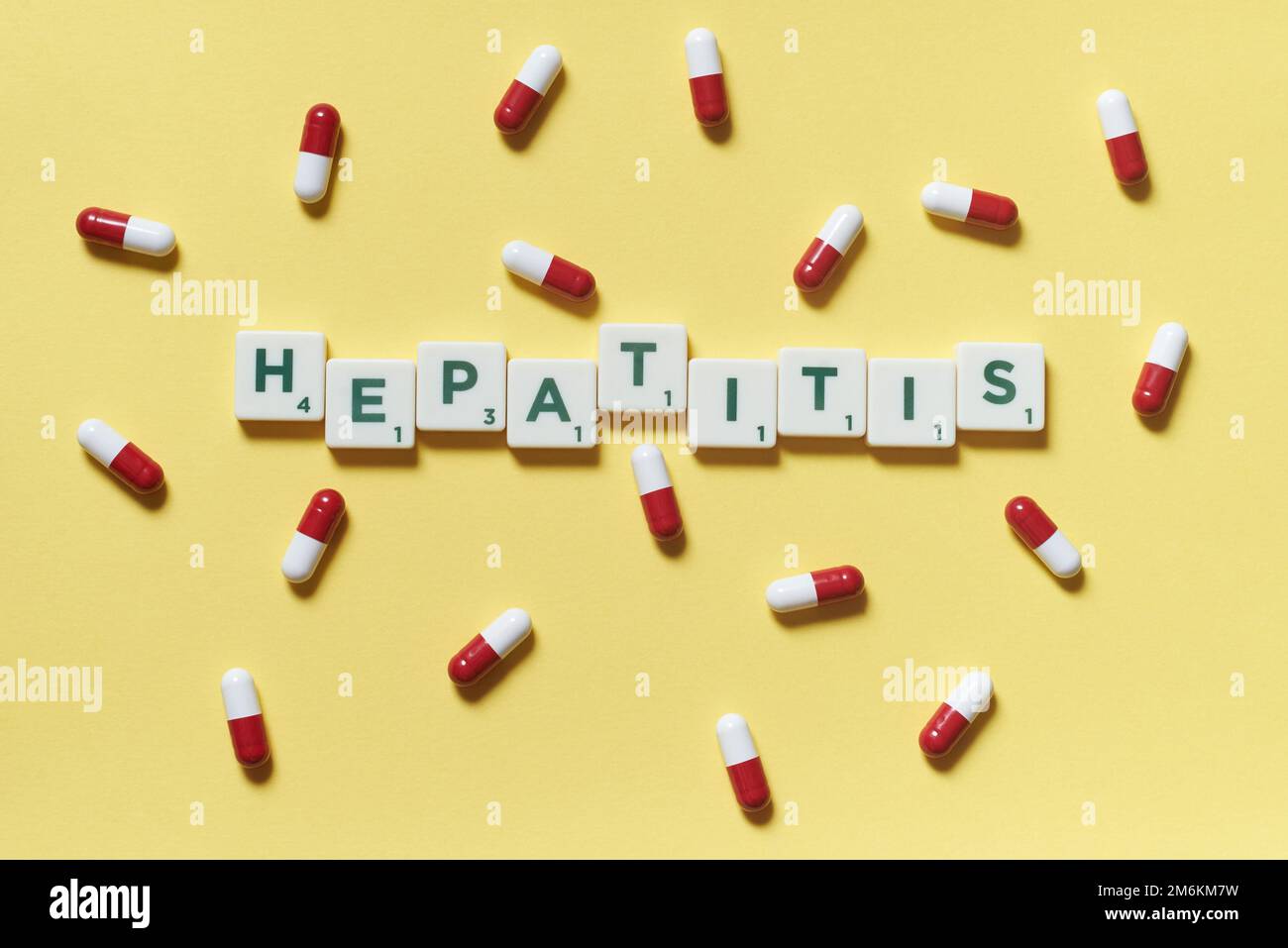 Hepatitis formed of scrabble blocks and pharmaceutical pills Stock ...
