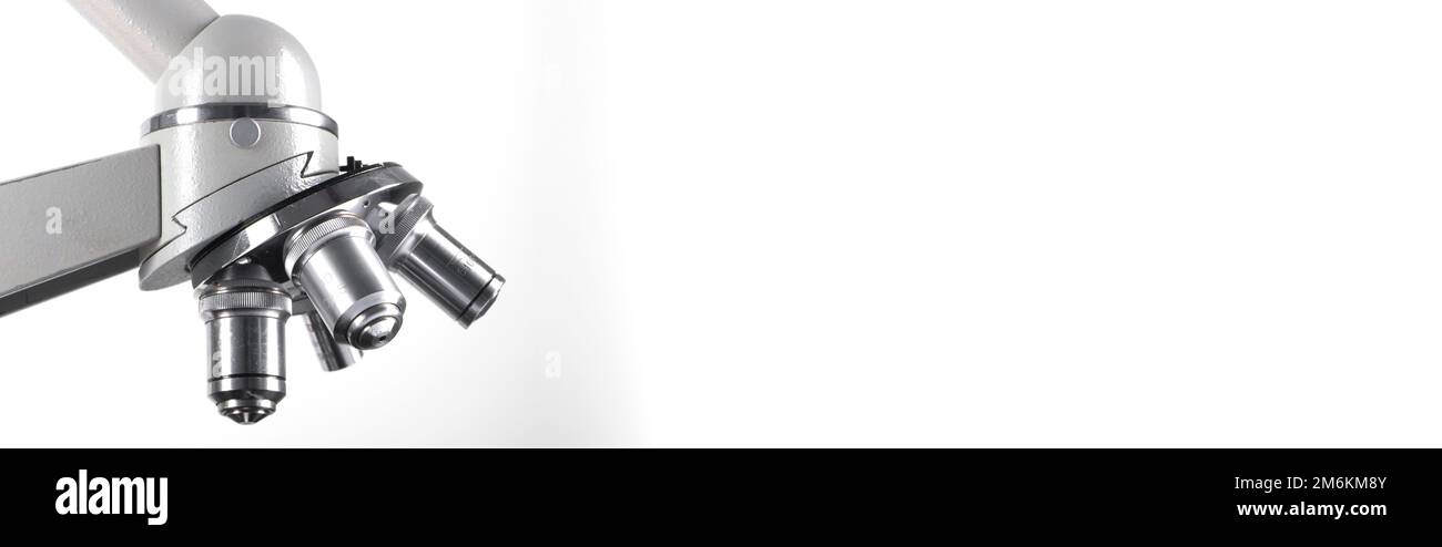 A microscope with three lenses on a white background. Concept, research ...