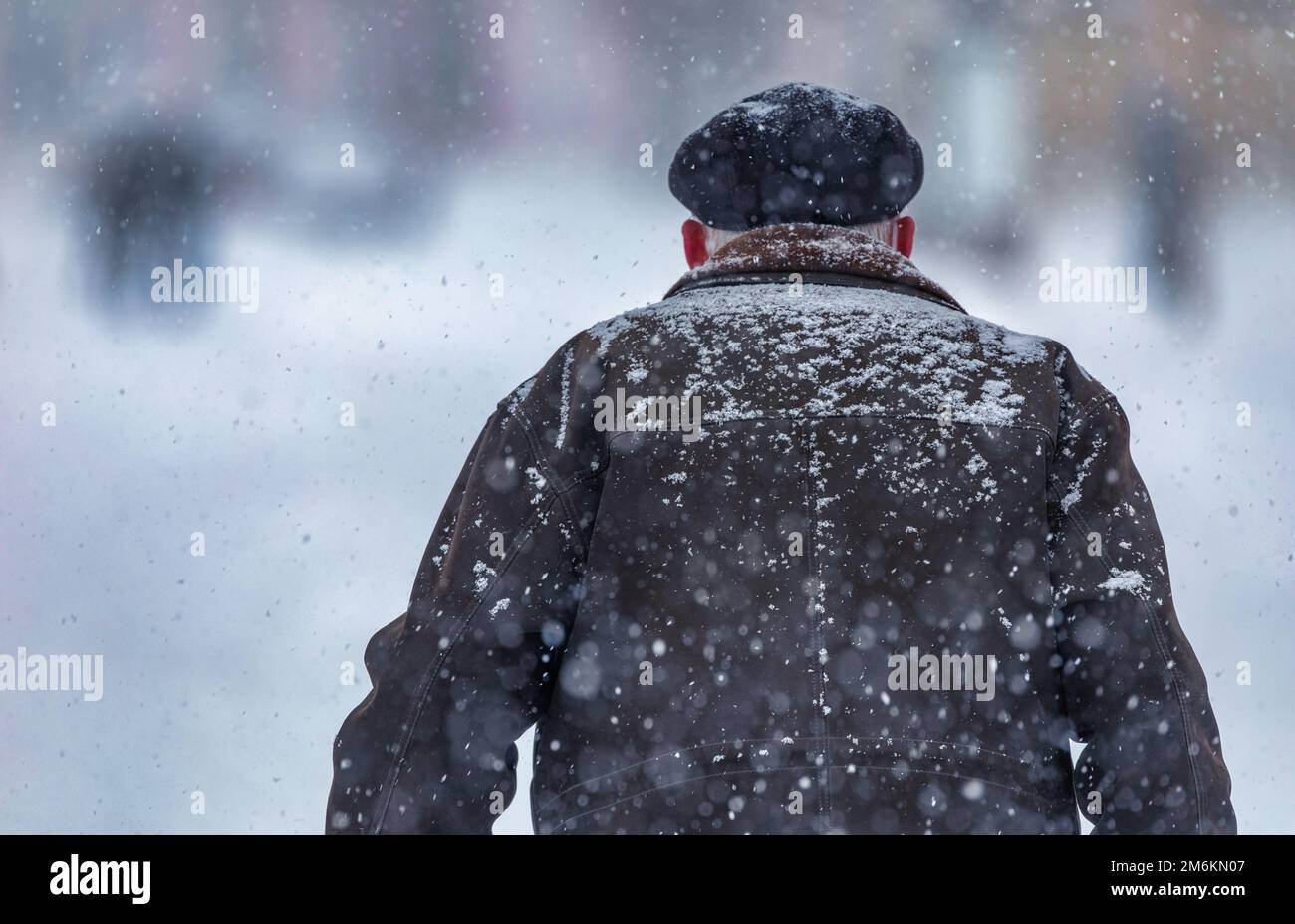Man outdoors in winter clothes during blizzard and heavy snowfall ...