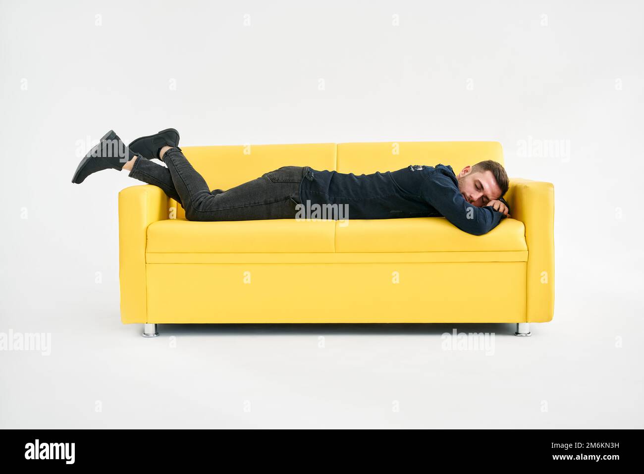 Man lying down on sofa hi-res stock photography and images - Alamy