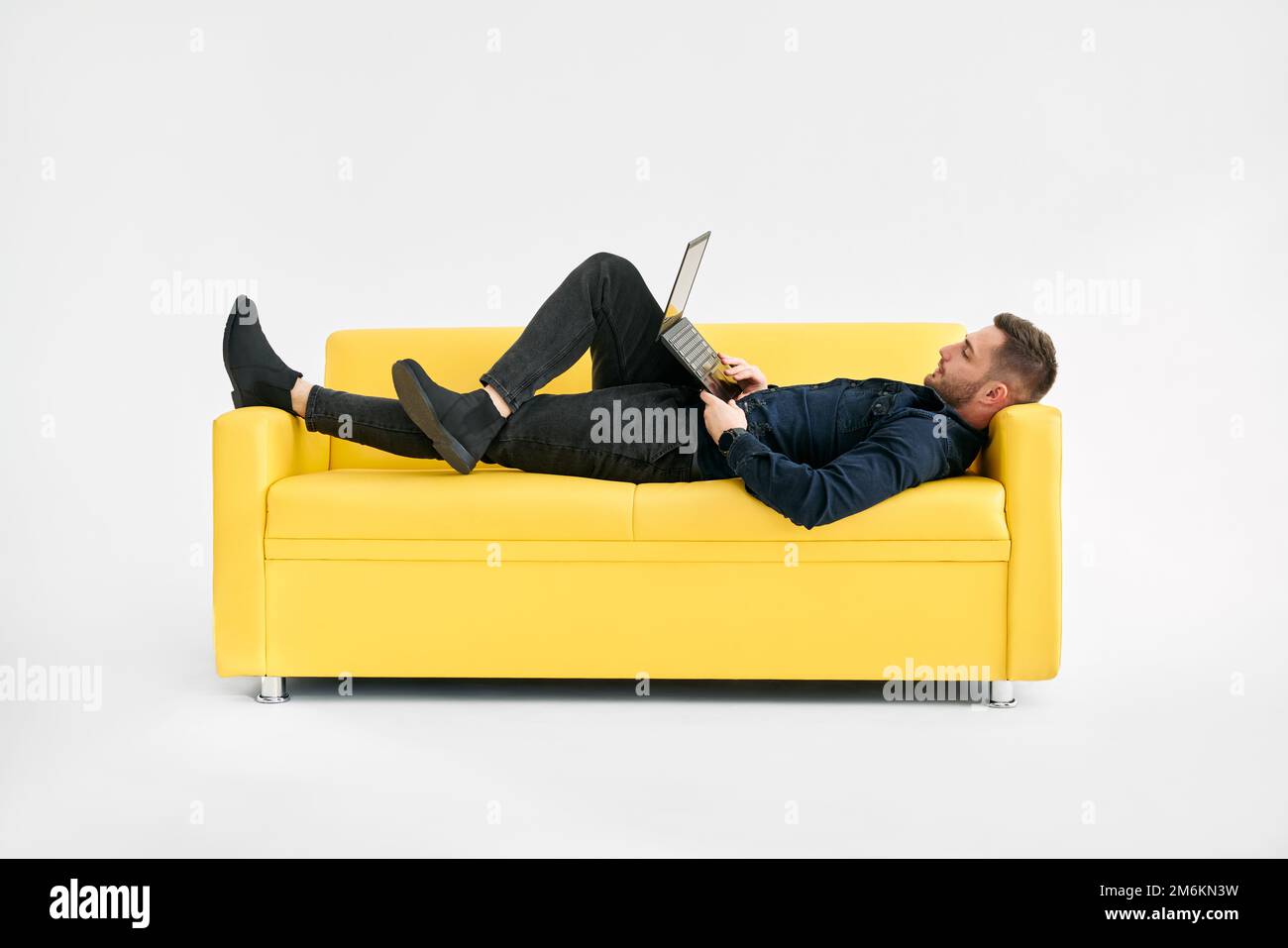 Man lying on couch using hi-res stock photography and images - Alamy