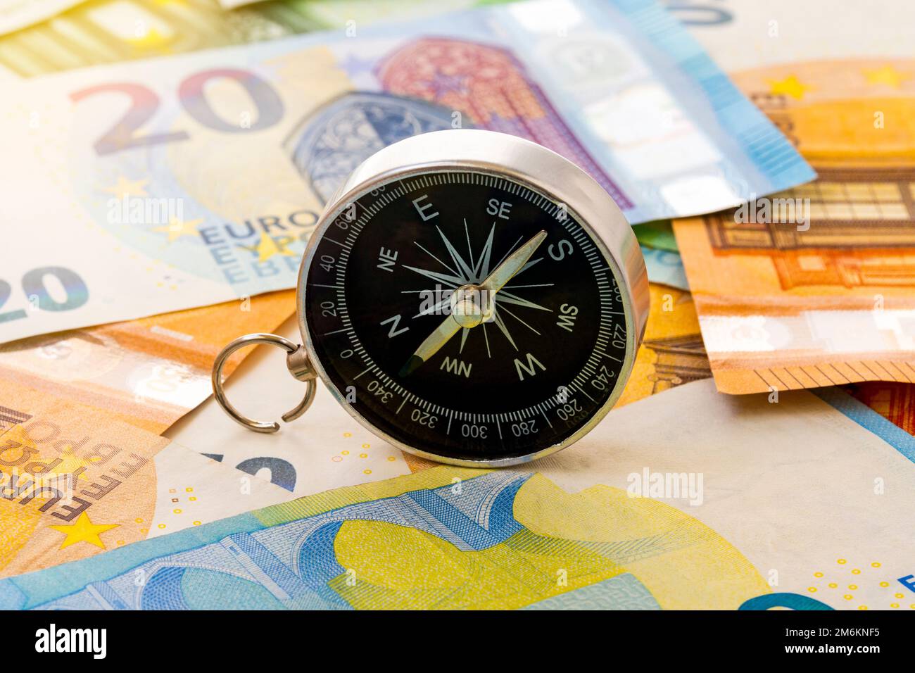 Black compass on euro currency banknotes Stock Photo - Alamy