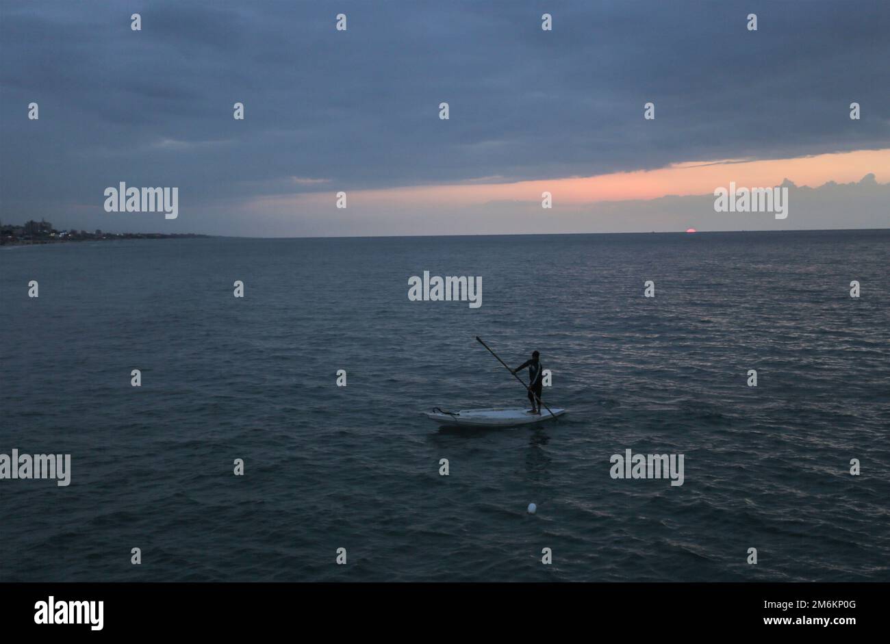 A Palestinian seen on a fishing boat during sunset along the seashore ...