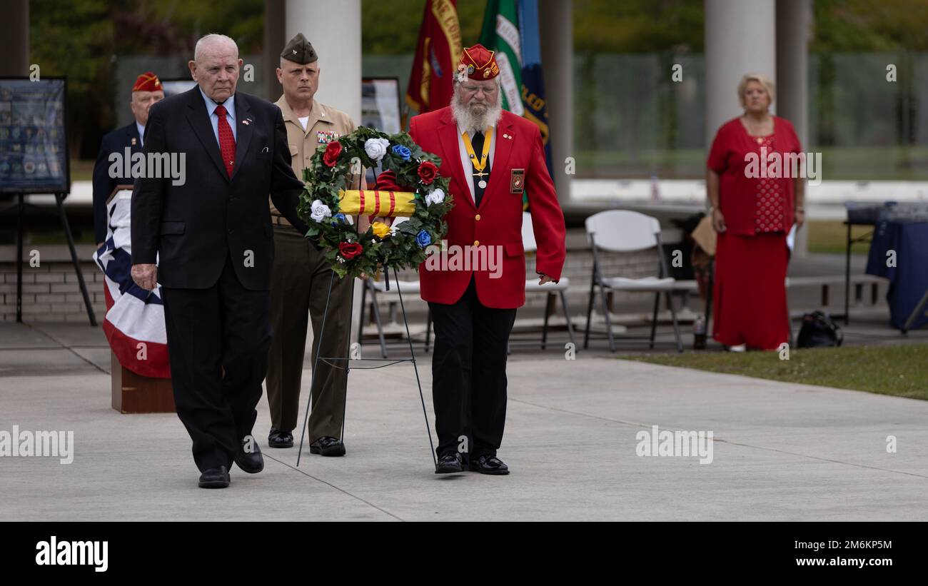 U.S. Marine Corps retired Maj. Frank McCarthy, left, walks with Col ...