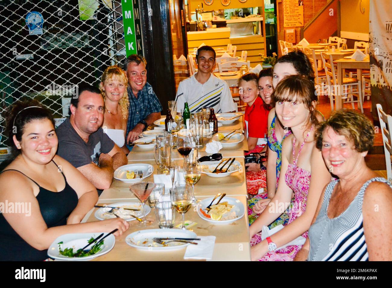group photo of tour group enjoying an evening meal together Stock Photo ...